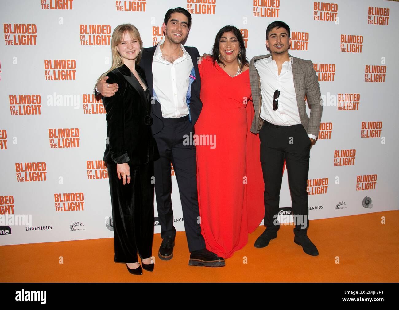 Director and writer Gurinder Chadha, in red, poses for photographers ...