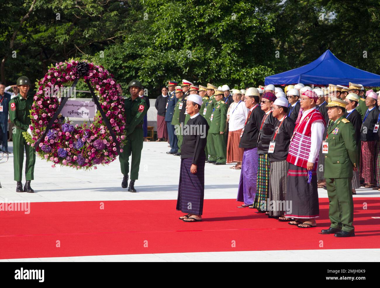 Myanmar President Win Myint, center, prepares to lay flower wreath ...