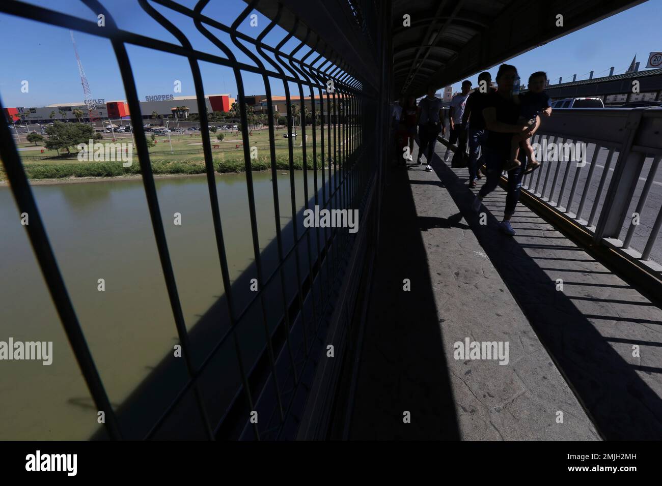 People walk back to Mexico on International Bridge 1 Las Americas, a ...