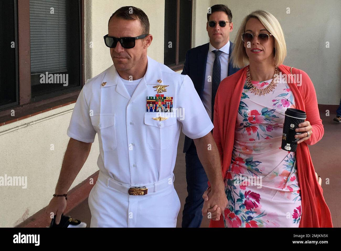 Navy Special Operations Chief Edward Gallagher, left, walks with his ...
