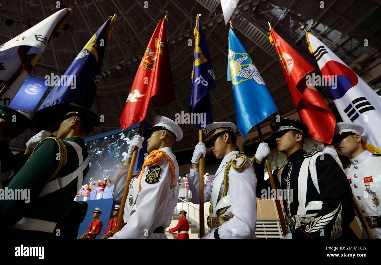 South Korean honor guard soldiers hold flags during a ceremony to mark ...