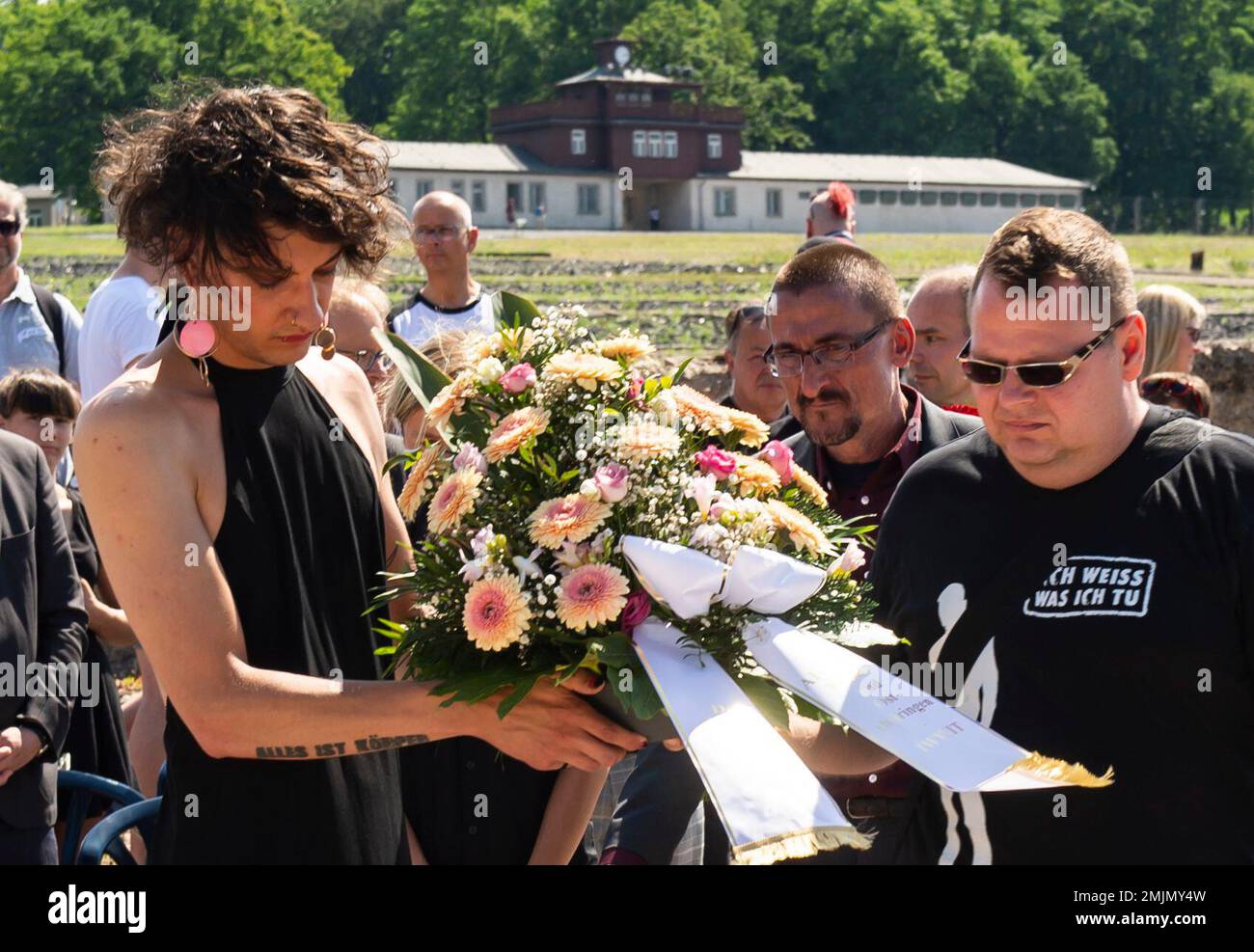 People lay a wreath in remembrance for prisoners assigned a pink ...