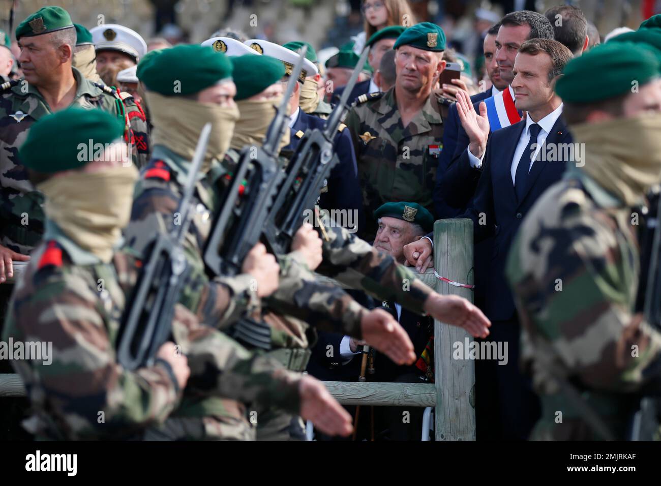French President Emmanuel Macron, right, holds the hand of French war ...