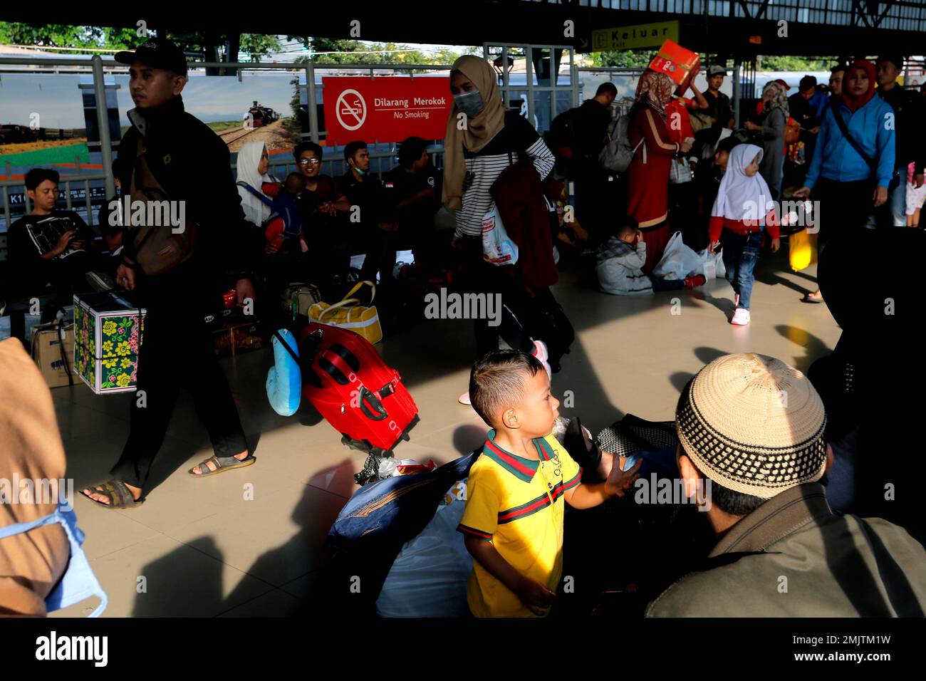 People wait for a train at Pasar Senen Station in Jakarta, Indonesia ...