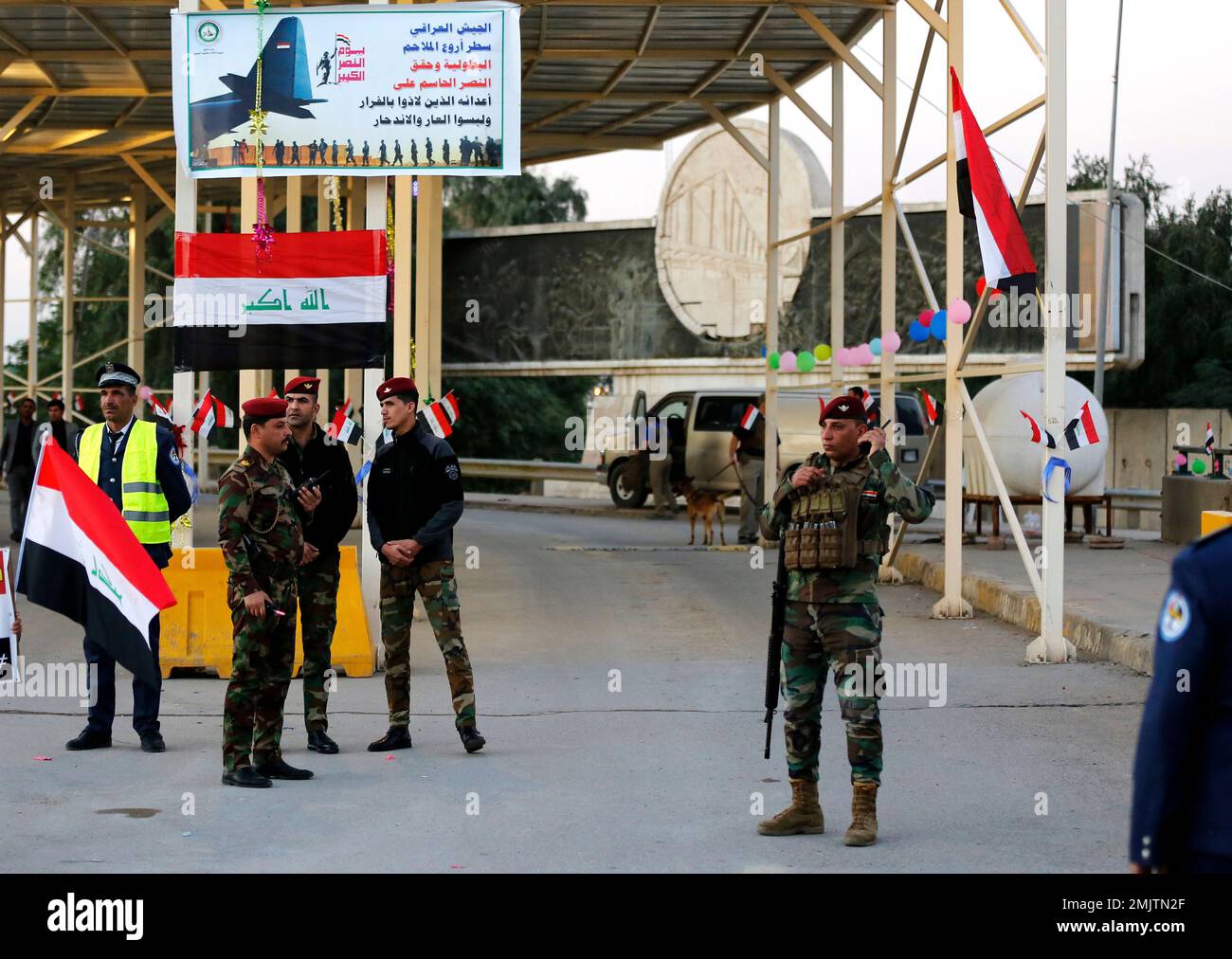 FILE - In this Dec. 10, 2018 file photo, Iraqi security forces stand ...