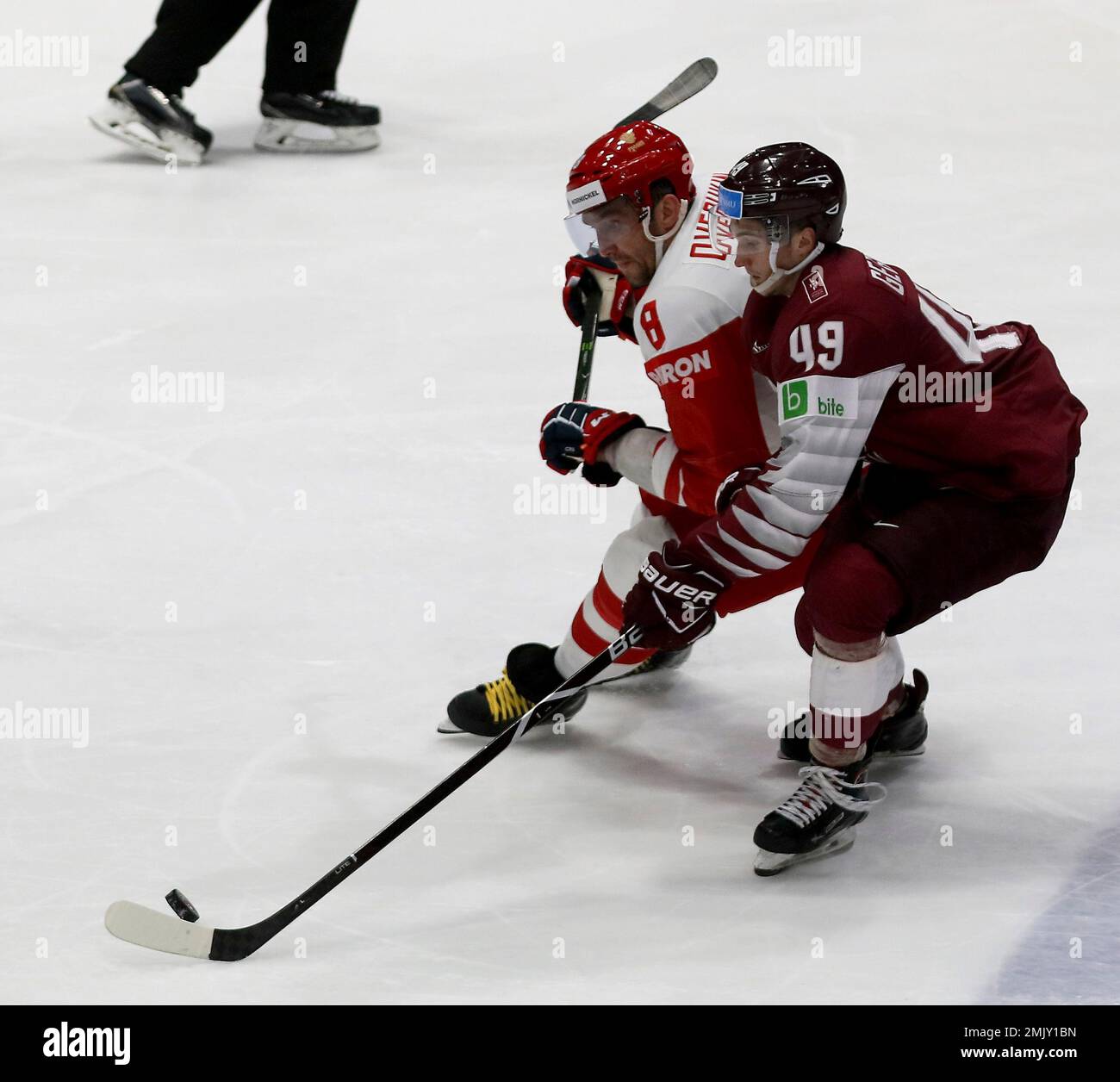 Russia's Alexander Ovechkin checks Latvia's Emils Gegeris, from left ...