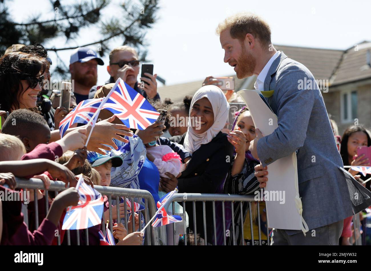 Britain's Prince Harry, The Duke of Sussex hugs a congratulations card ...