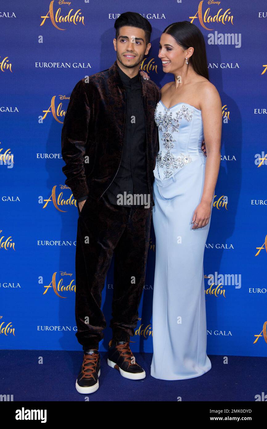 Actors Naomi Scott, right and Mena Massoud pose for photographers upon ...