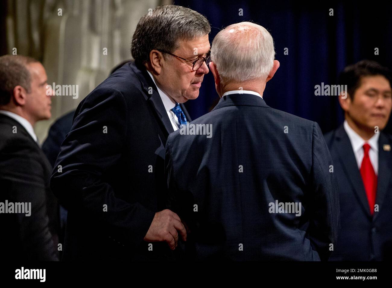 Attorney General William Barr, left, speaks with former Attorney ...