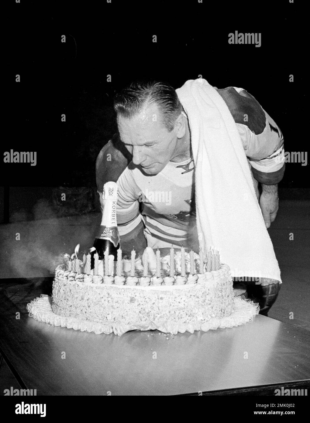 Toronto Maple Leafs goalie Johnny Bower blows out the candles on his ...