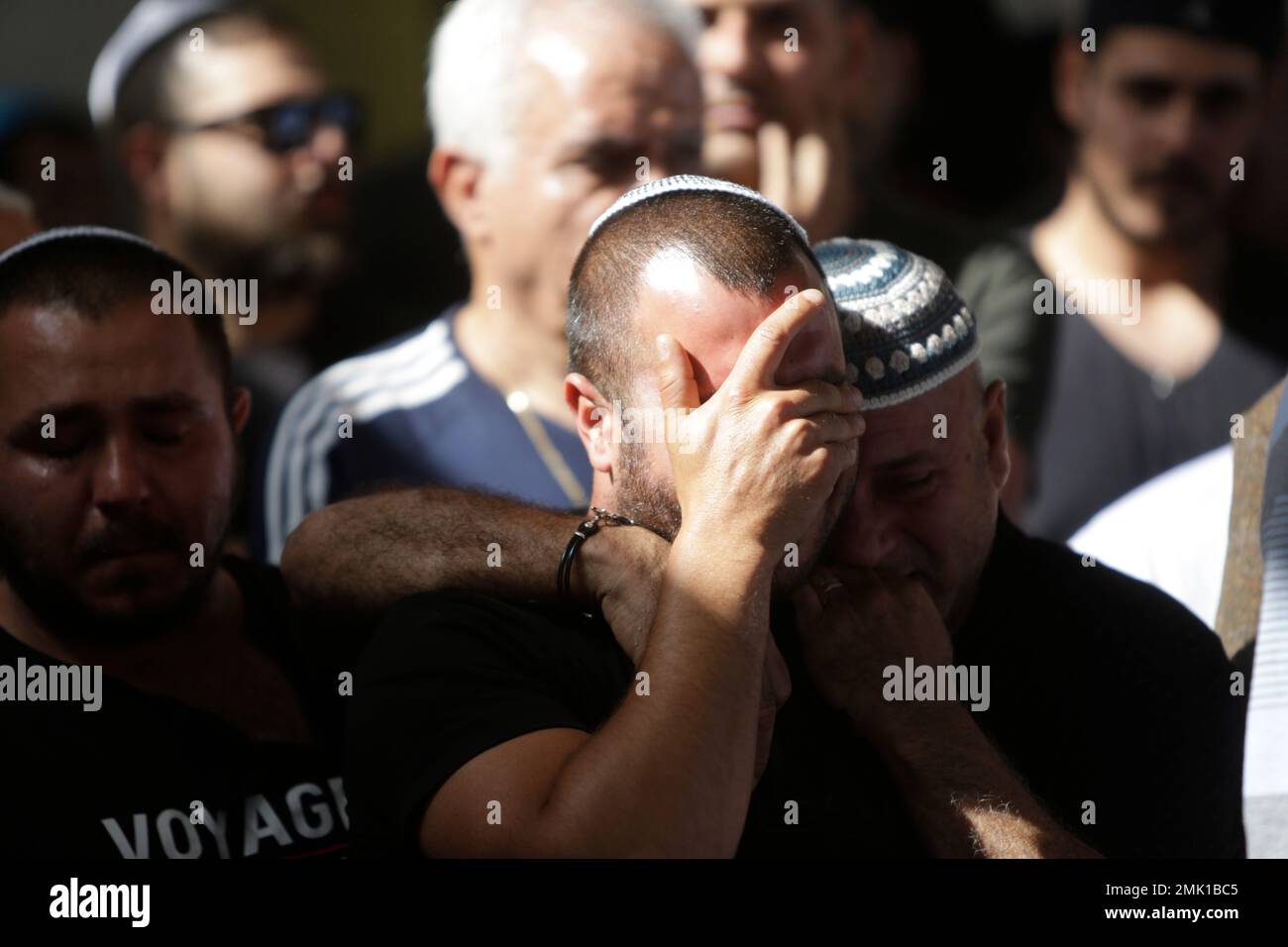 People cry during the funeral of Moshe Agadi in the city of Ashkelon ...