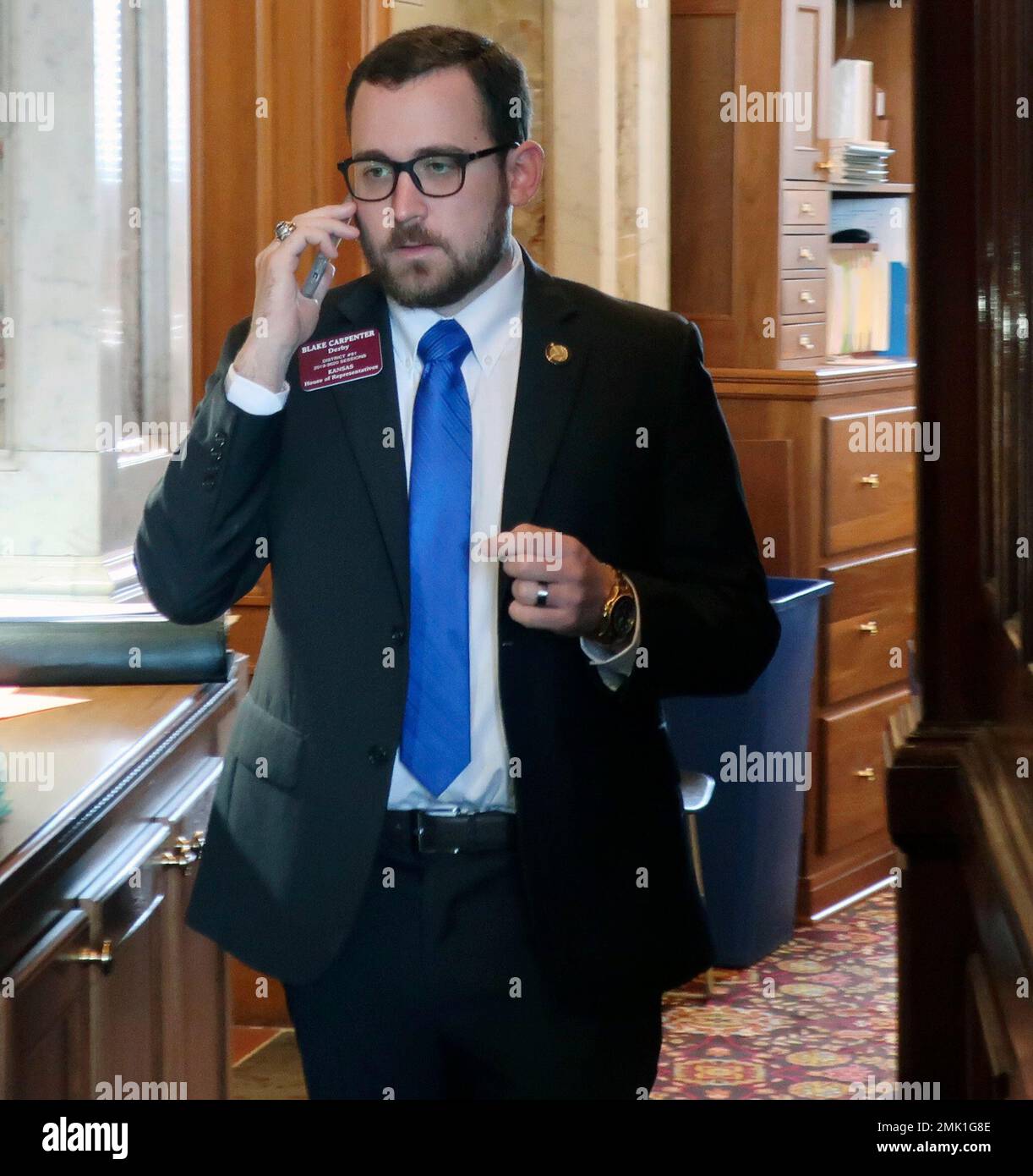 Kansas state Rep. Blake Carpenter, R-Derby, talks on his cell phone ...