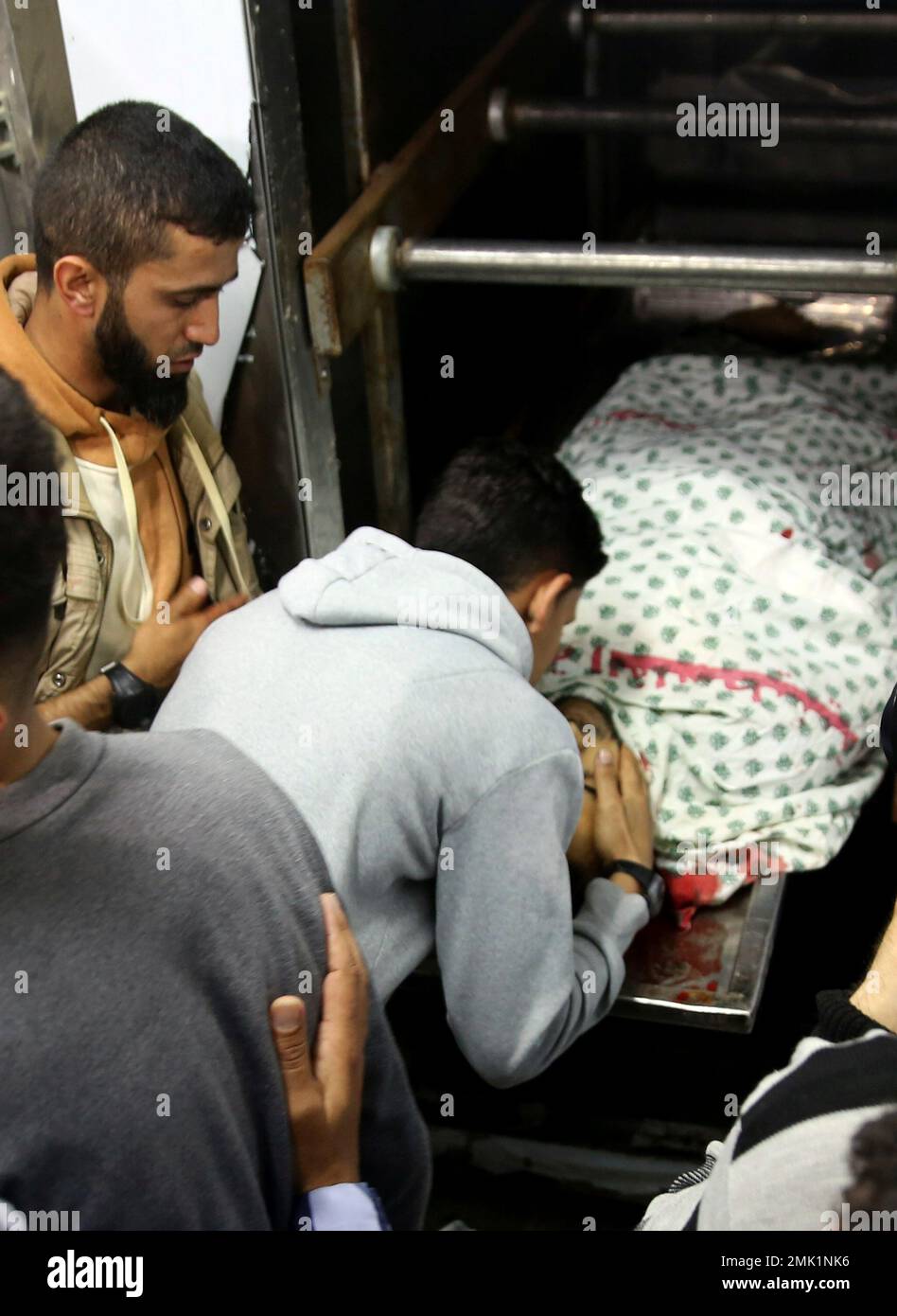 EDS NOTE: GRAPHIC CONTENT - A mourner kisses the body of Hamas militant ...