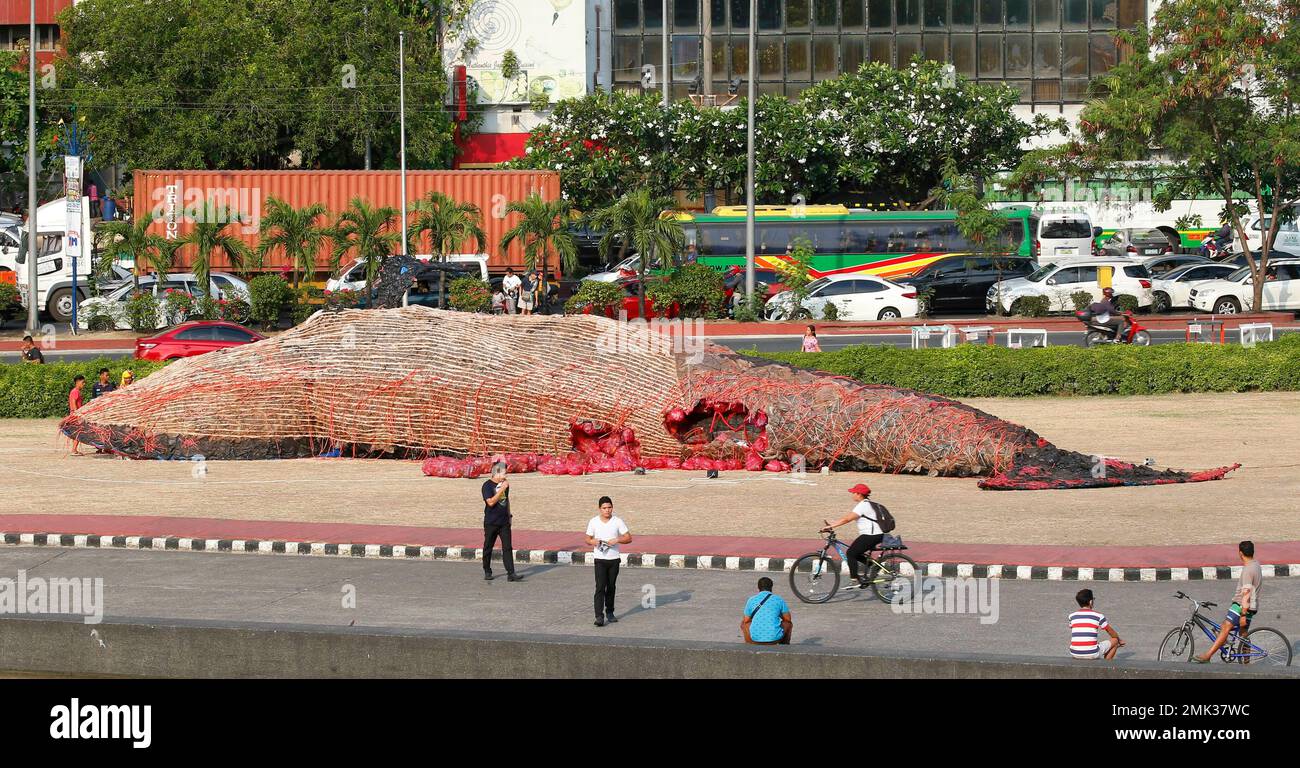 People view an art installation of a beached blue whale with its ...
