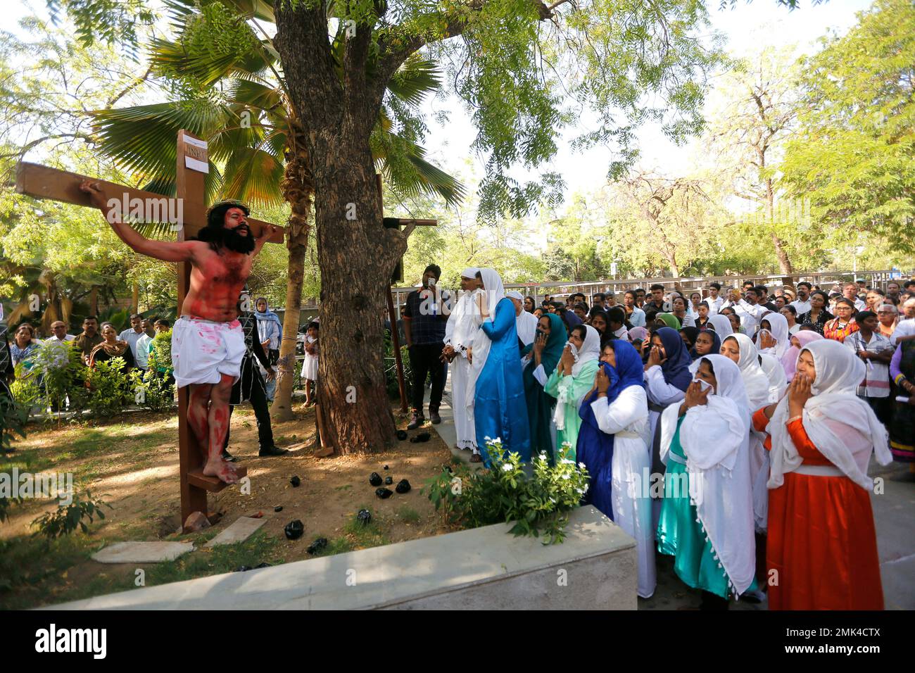 Christians watch a reenactment of the crucifixion of Jesus Christ during a Good Friday ...