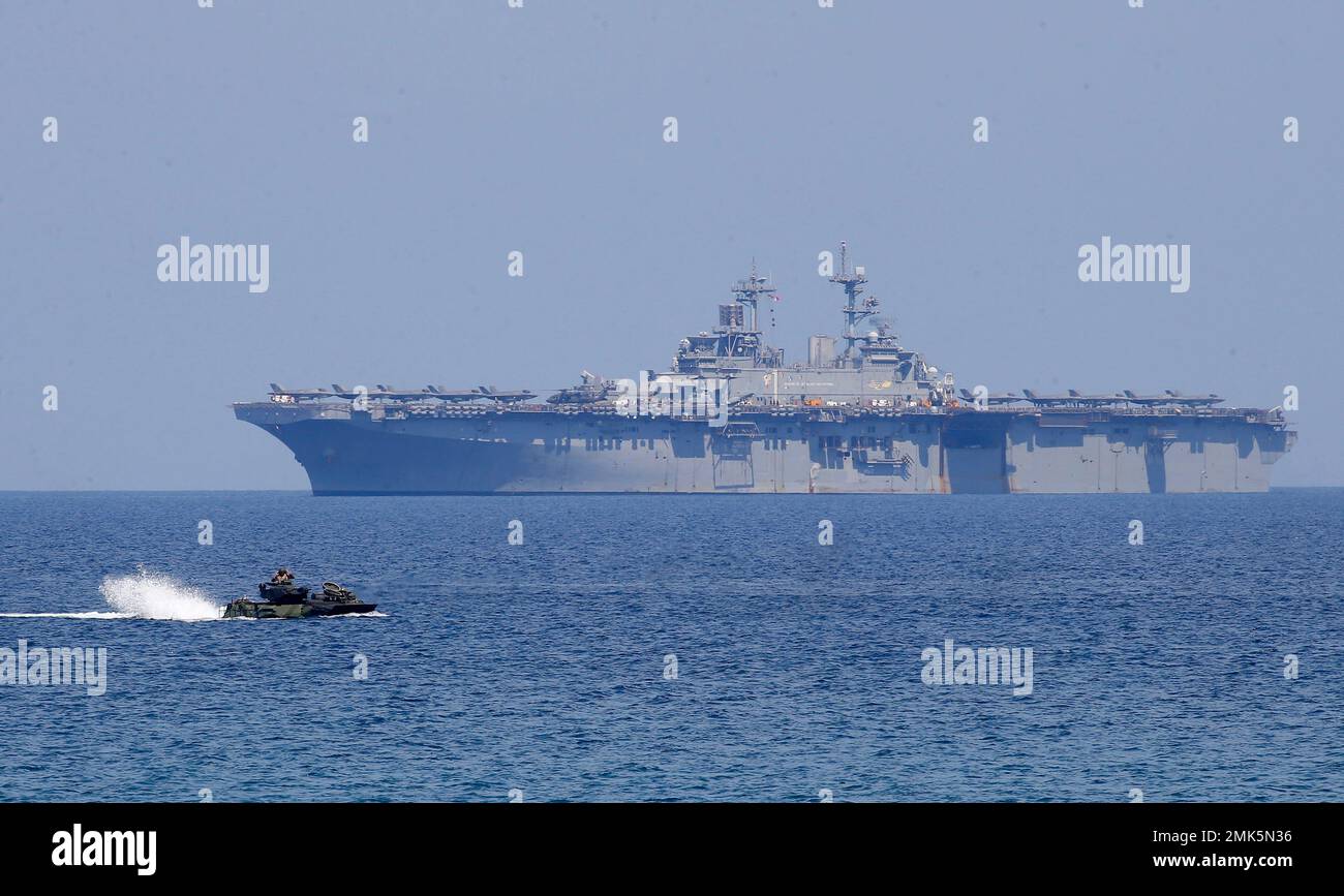 US Navy's multipurpose amphibious assault ship USS WASP cruises in the background after ...