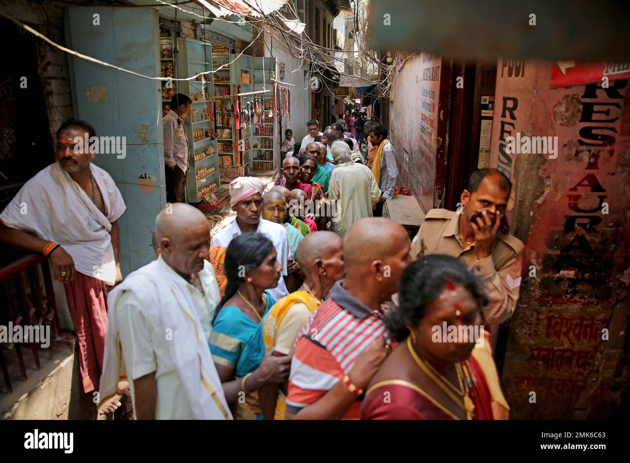 In this March 22, 2019, photo, Hindu devotees stand in queue in a ...