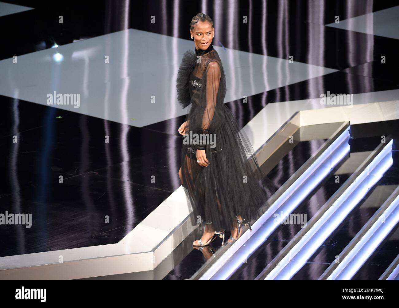 Letitia Wright looks back to the audience before going on stage to ...