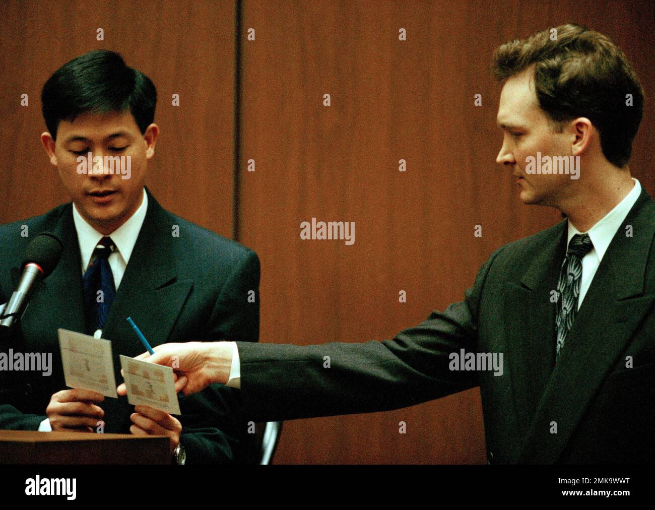 Prosecutor Hank Goldberg shows criminalist Dennis Fung pictures of ...