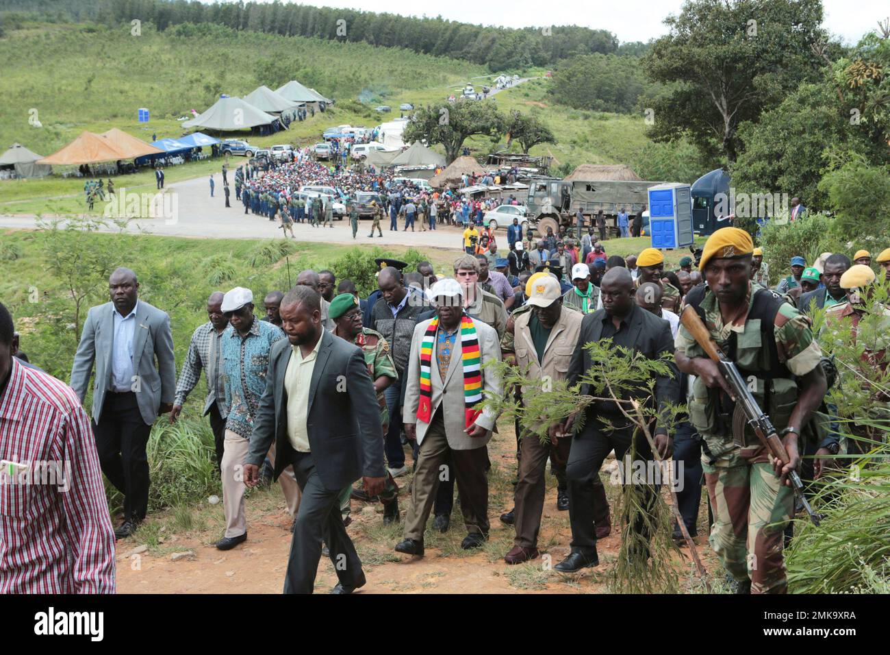 Zimbabwean President Emmerson Mnangagwa, center with scarf, visits ...