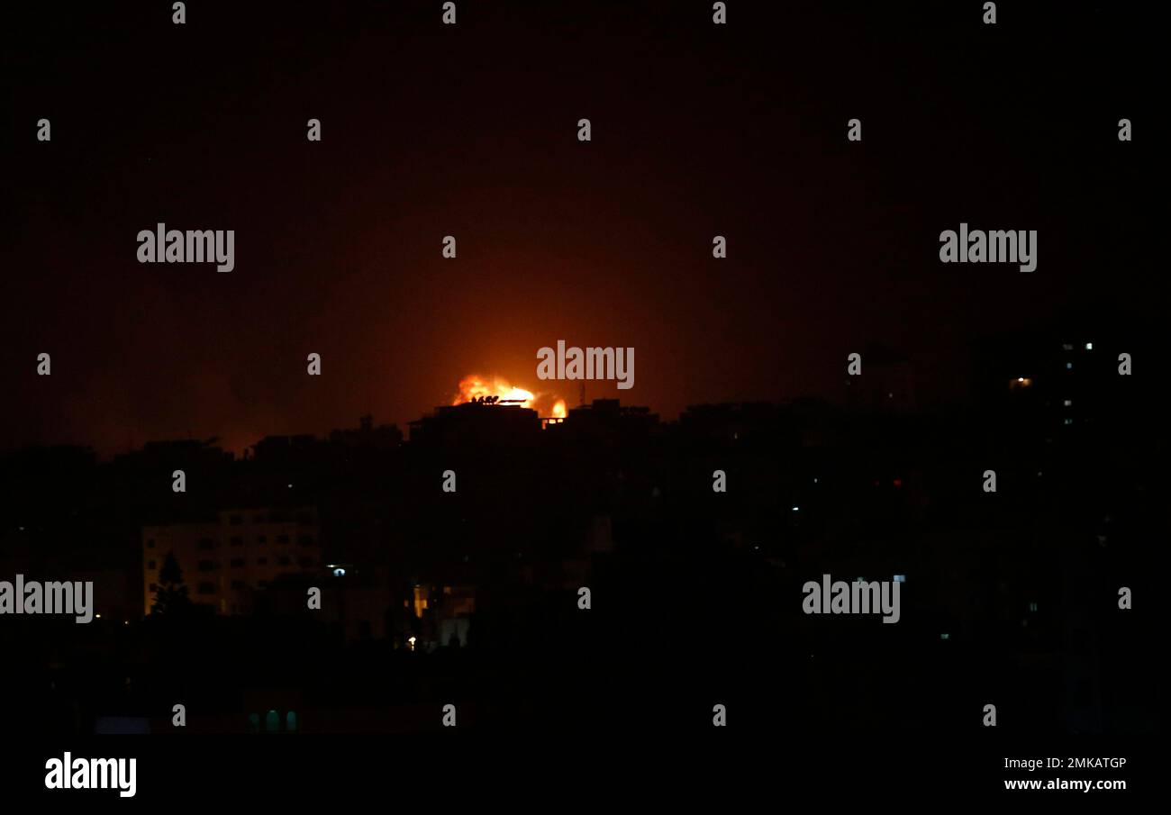 An explosion caused by Israeli airstrikes is seen on Gaza City, early ...