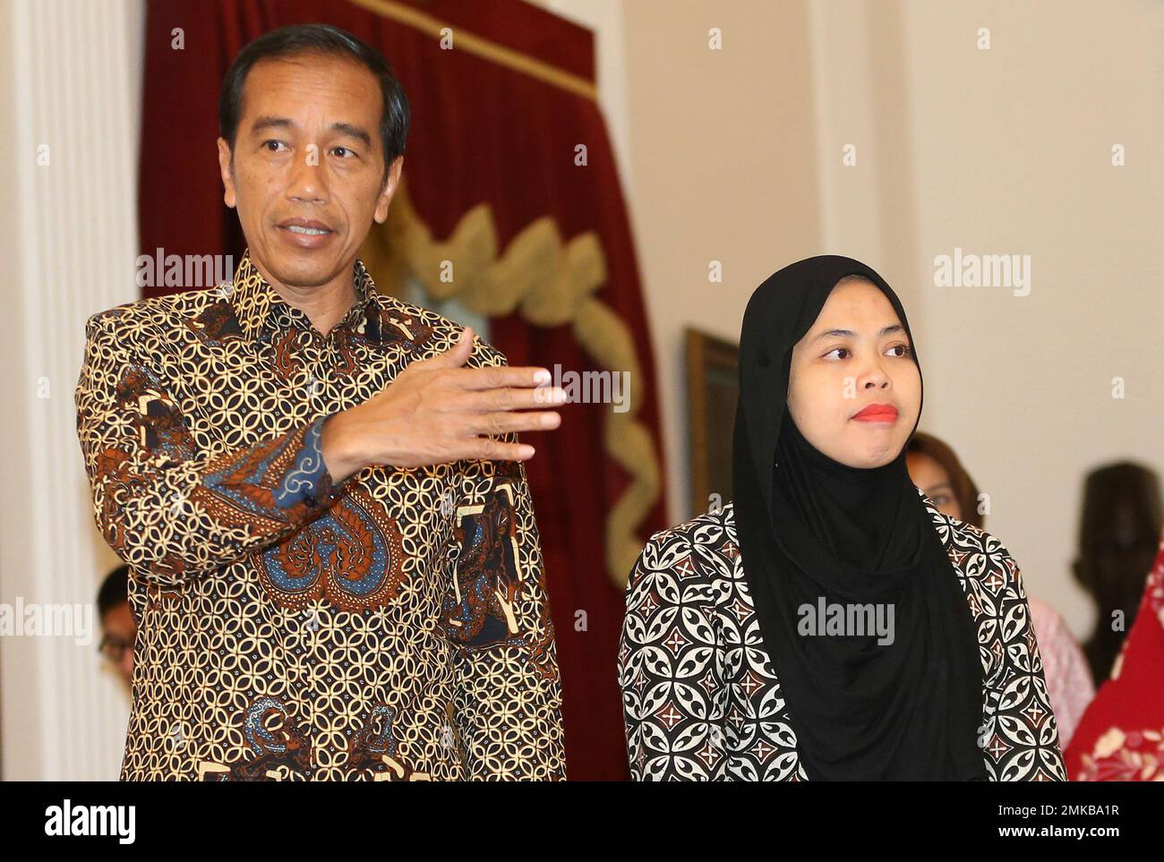 Indonesian president Joko Widodo, left, walks with Siti Aisyah ...