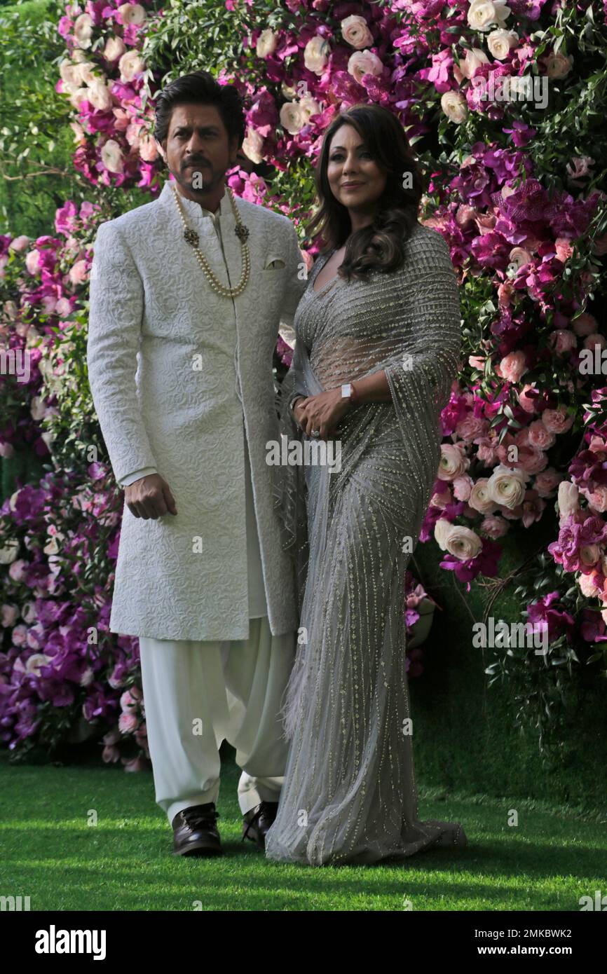 Bollywood actor Shah Rukh Khan and his wife Gauri Khan stand for ...