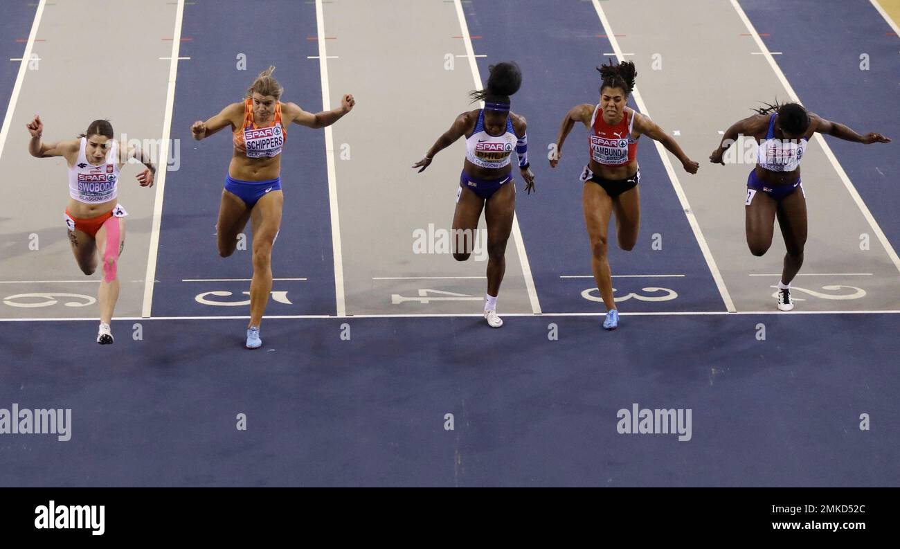 Poland's Ewa Swoboda, left, crosses the finish line to win in the women ...