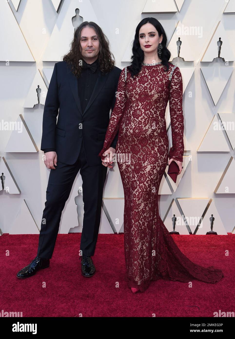 Adam Granduciel, left, and Krysten Ritter arrive at the Oscars on ...