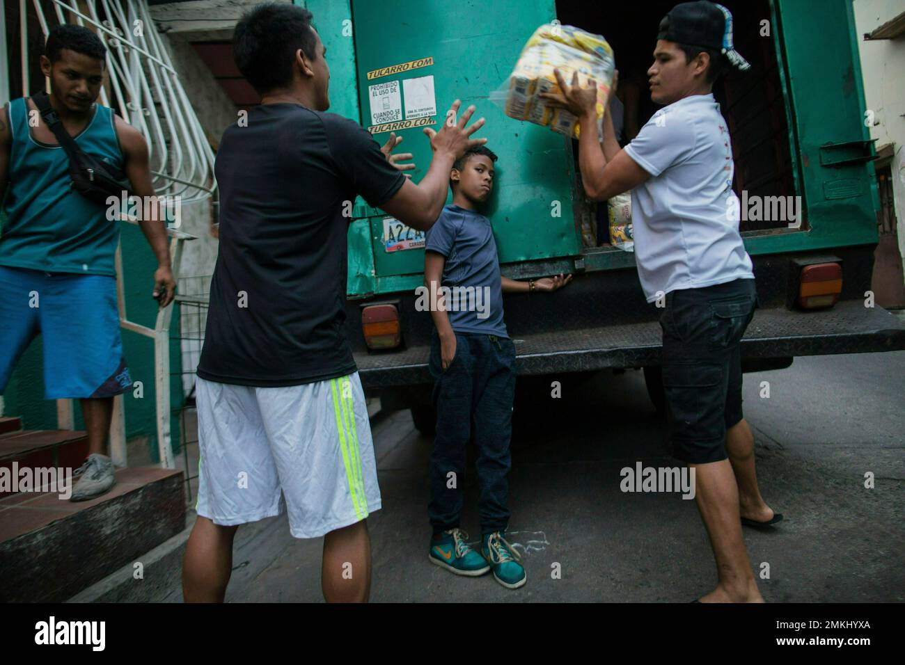 In this Jan. 31, 2019 photo, neighbors unload subsidized food ...