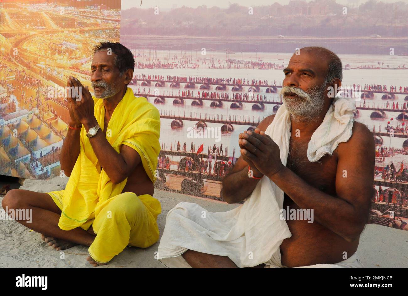 Indian Hindu devotees perform evening rituals at the Sangam, the ...