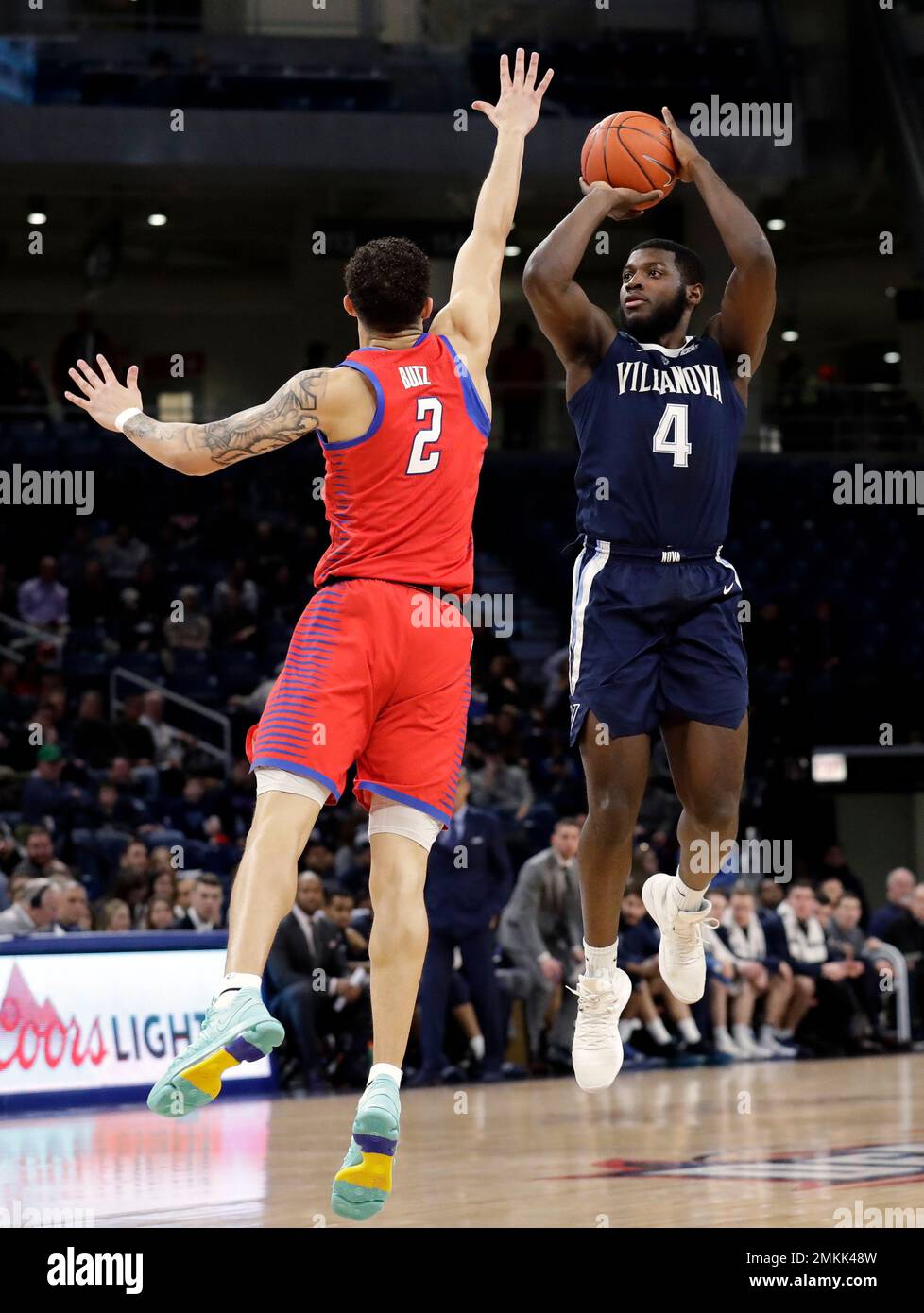 Villanova forward/guard Eric Paschall, right, shoots against DePaul ...