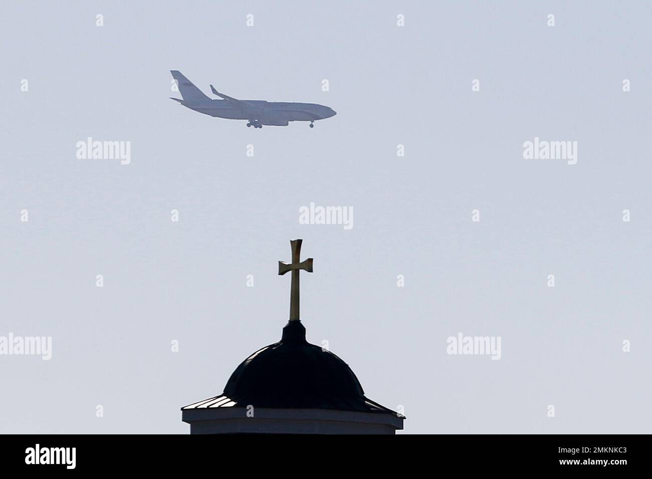 Russian President Vladimir Putin's plane seen as it flies over a church ...