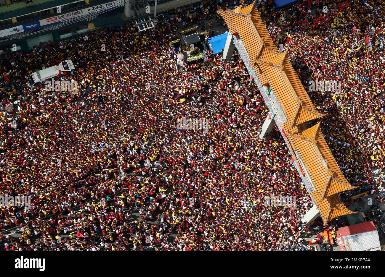 A massive crowd of Filipino Roman Catholic devotees follow the carriage ...
