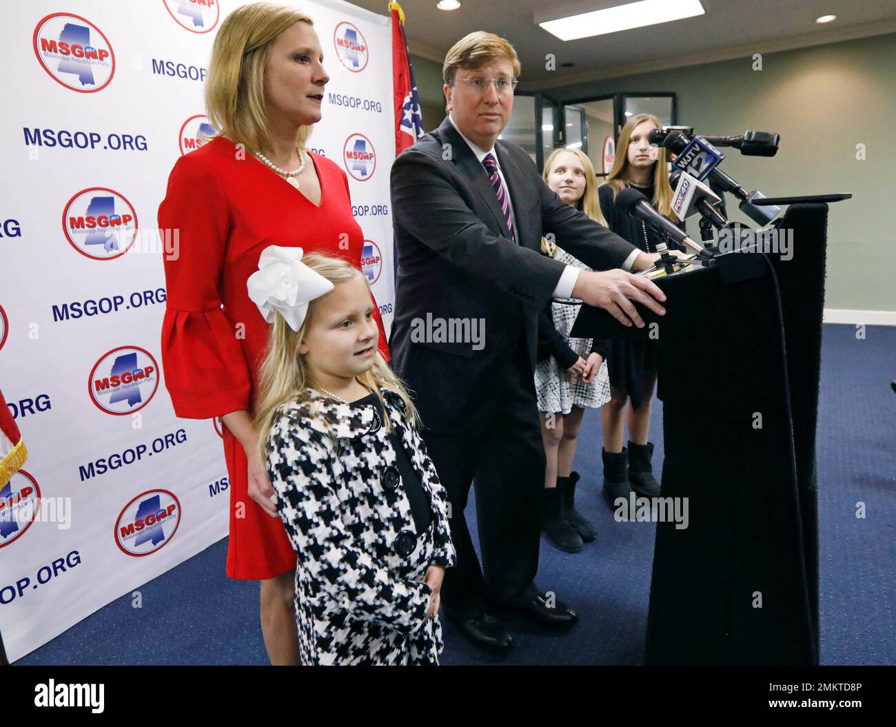 Flanked by his wife, Elee Reeves, second from left, daughters Maddie ...