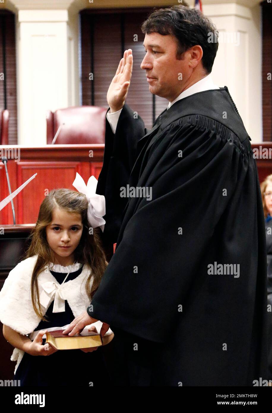 Meredith Tindell, 7, holds the Bible that her father, Sean Tindell, a ...