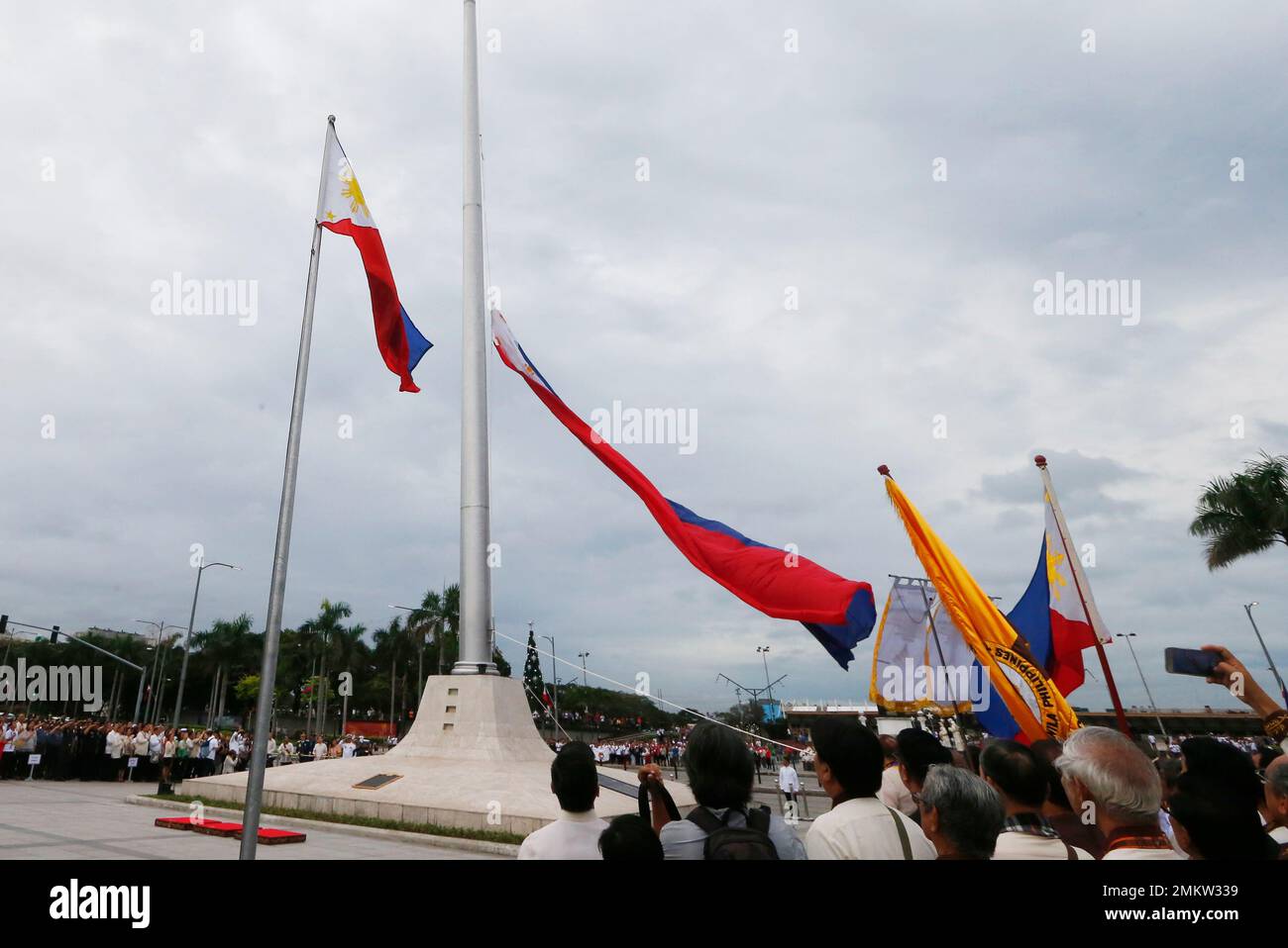 A Philippine flag is partly torn while being raised during flag-raising ...