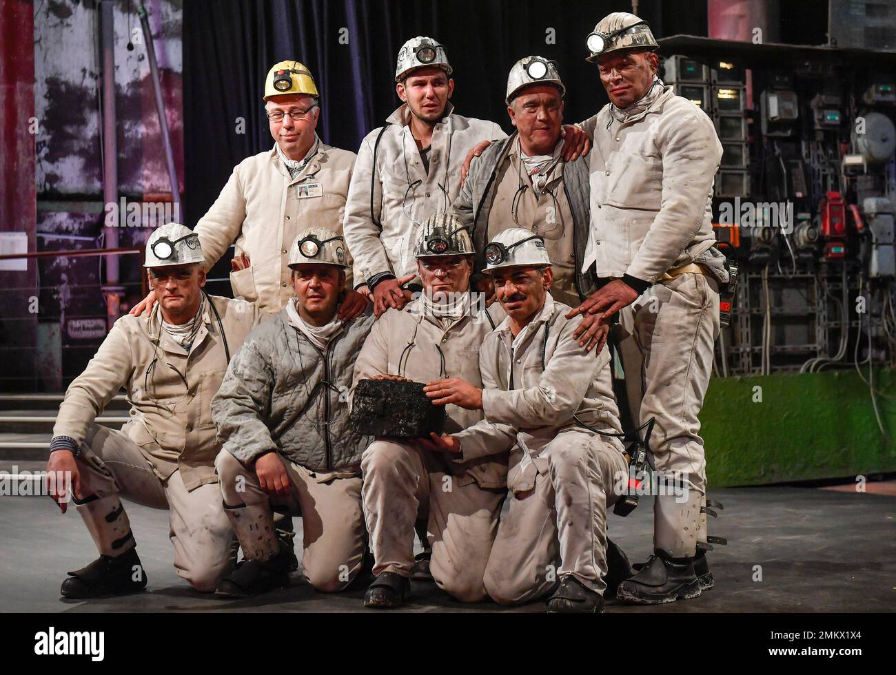 Miners pose together symbolically holding the last lump of coal during ...