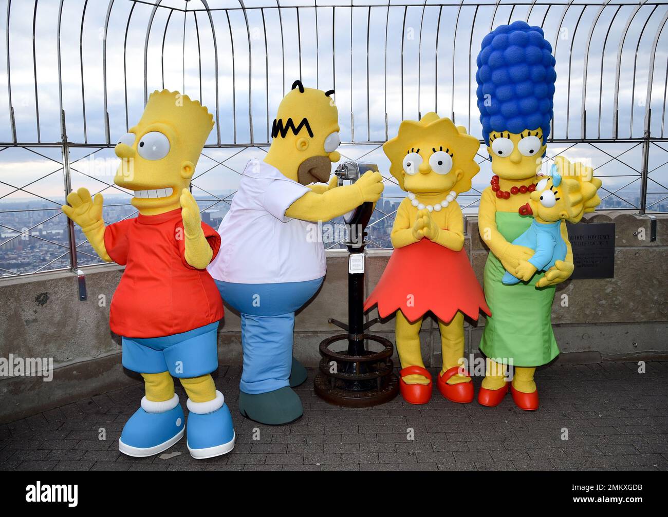 "The Simpsons" costumed characters, from left, Bart Simpson, Homer ...