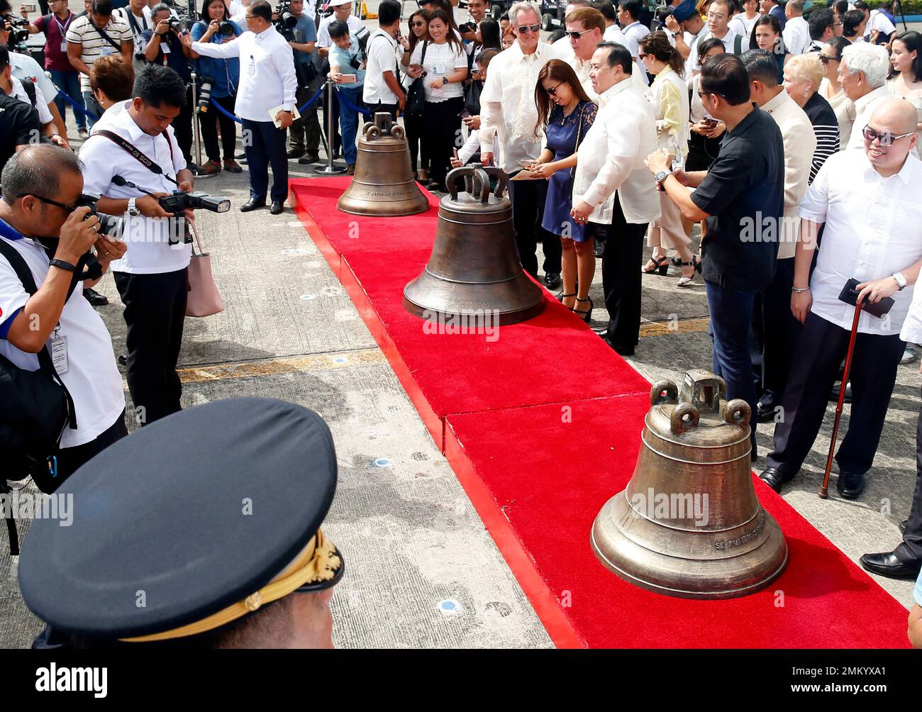 Guests gather for souvenir shots with three Balangiga church bells ...