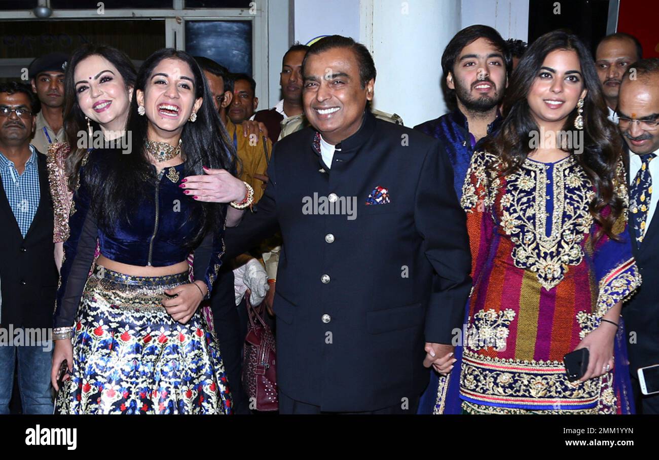 In this Friday, Nov. 30, 2018 photo, Chairman of Reliance Industries Mukesh Ambani, center, his ...