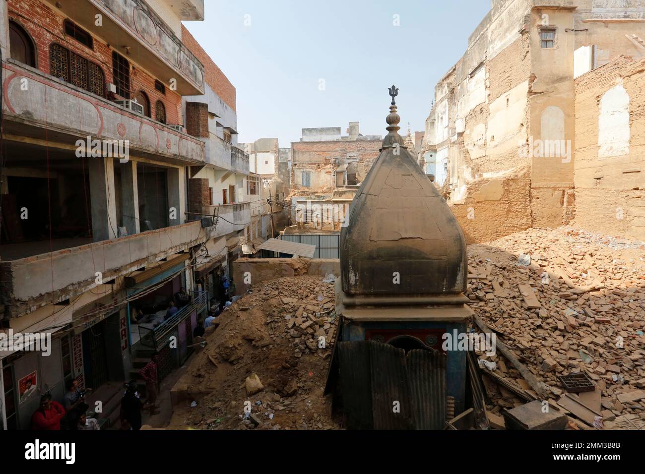 Rubble from demolished buildings cover a temple in Varanasi, India ...