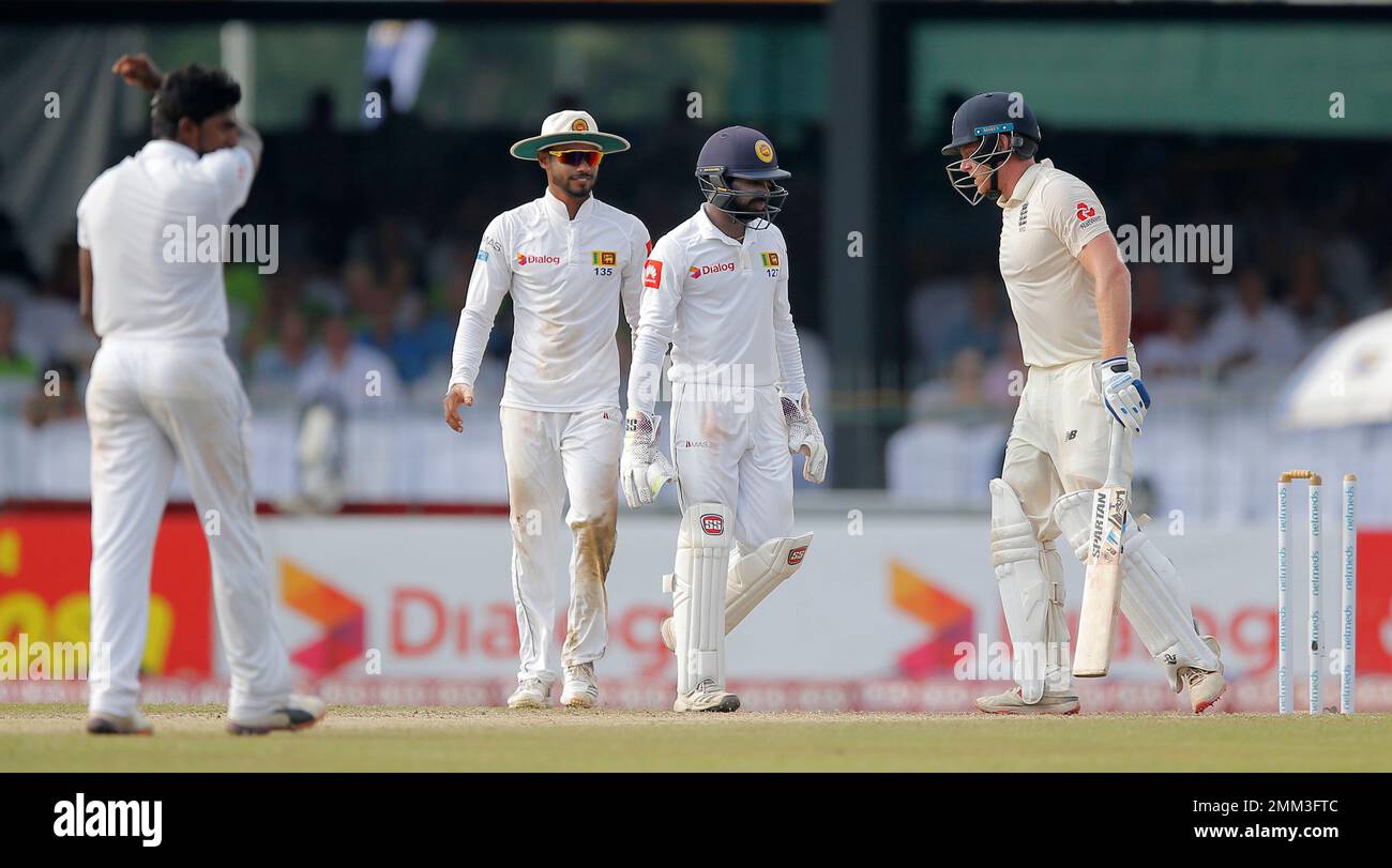 Sri Lanka's Lakshan Sandakan, left, is congratulated by teammates for ...