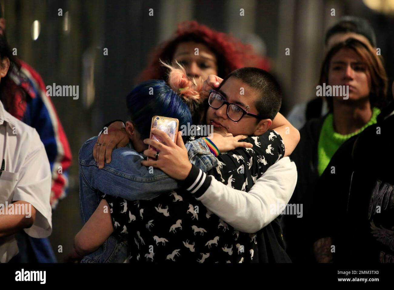 People embrace as dozens of transgender women and allies gather to ...