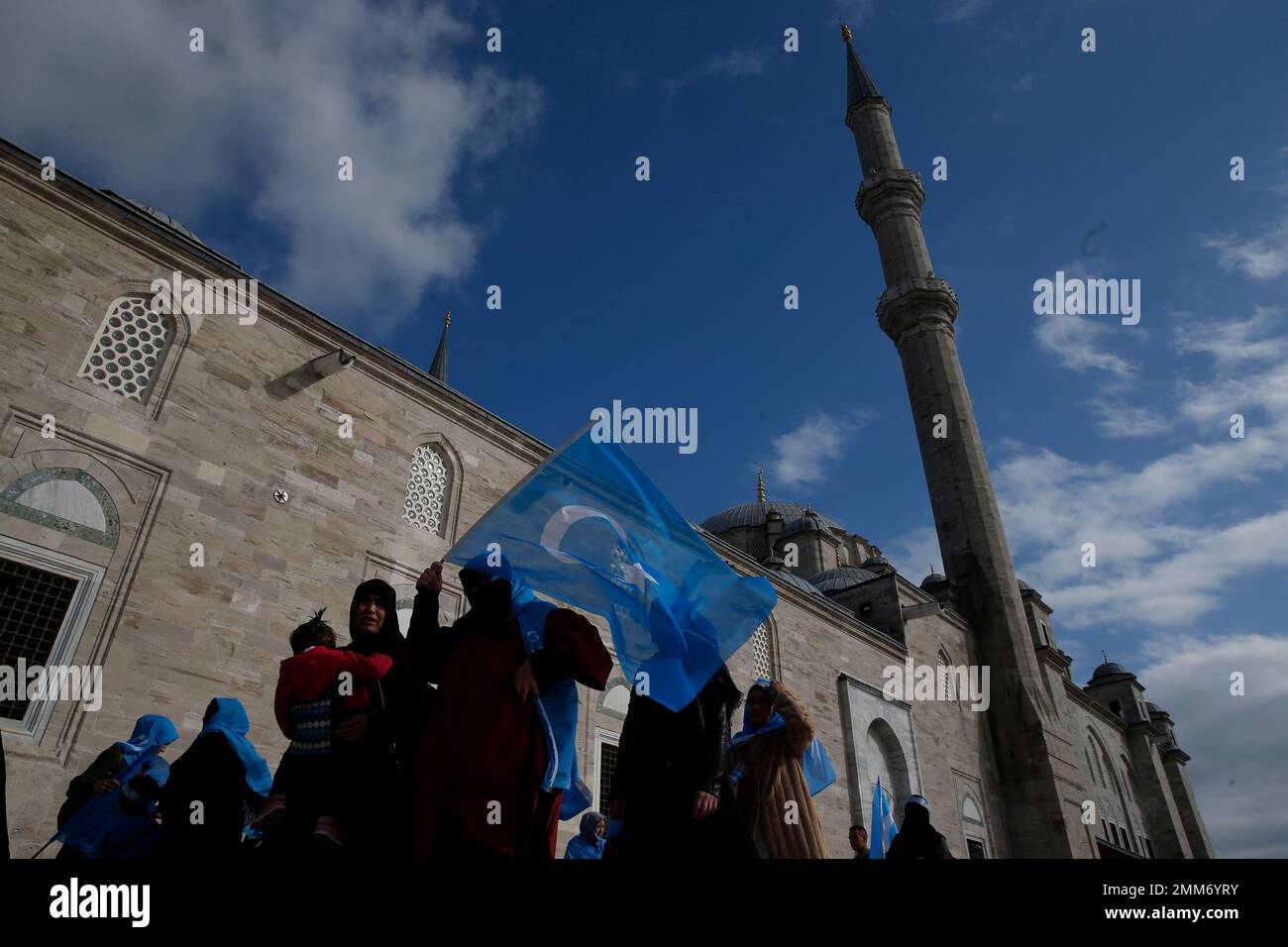 People from the Uighur community living in Turkey carrying flags of ...