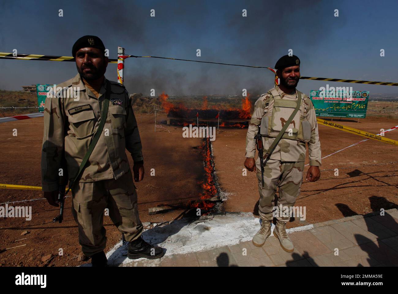 Soldiers from the anti-narcotics force stand guard as seized narcotics ...