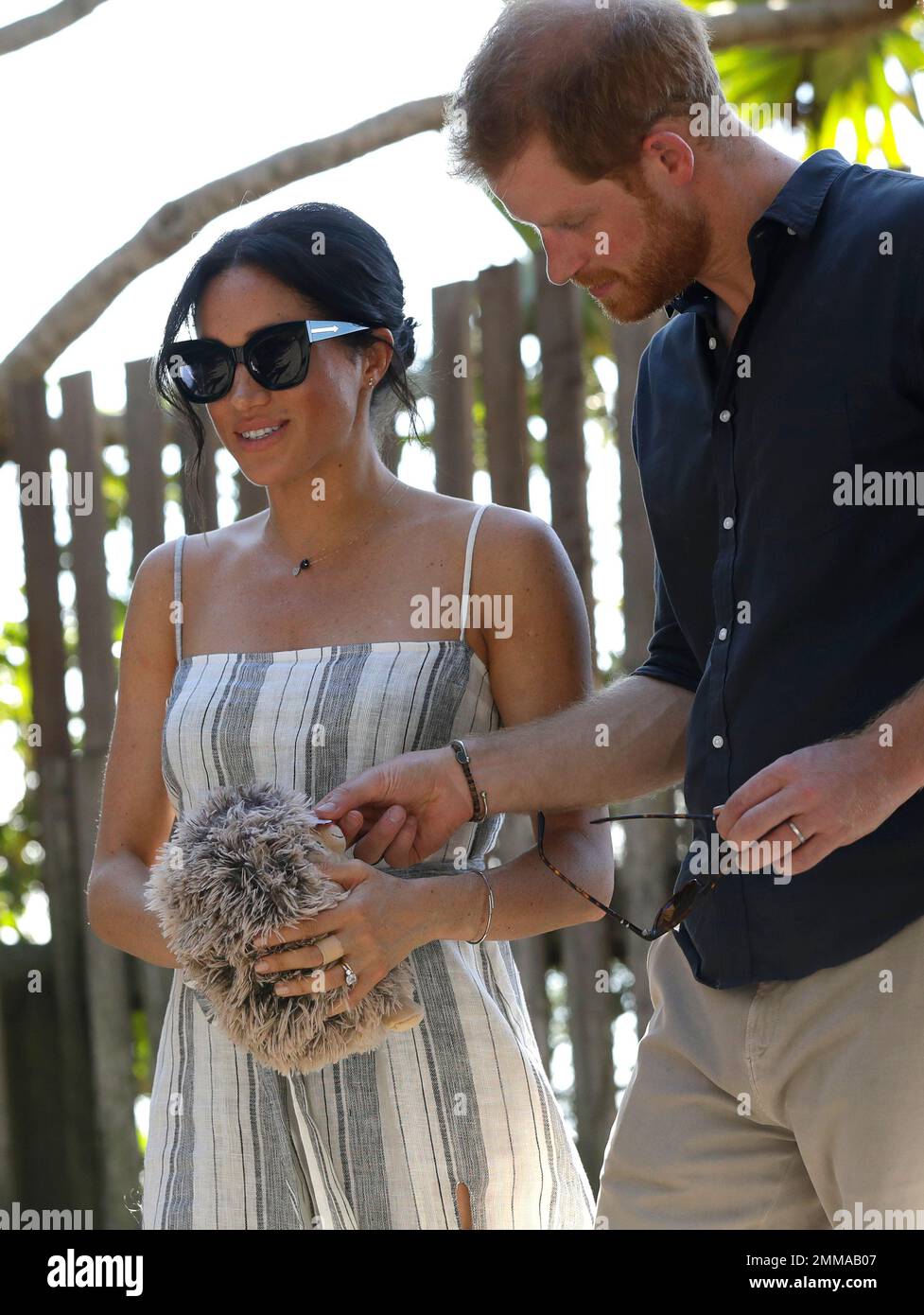 Meghan, Duchess of Sussex holds a gift from a member of the public as ...
