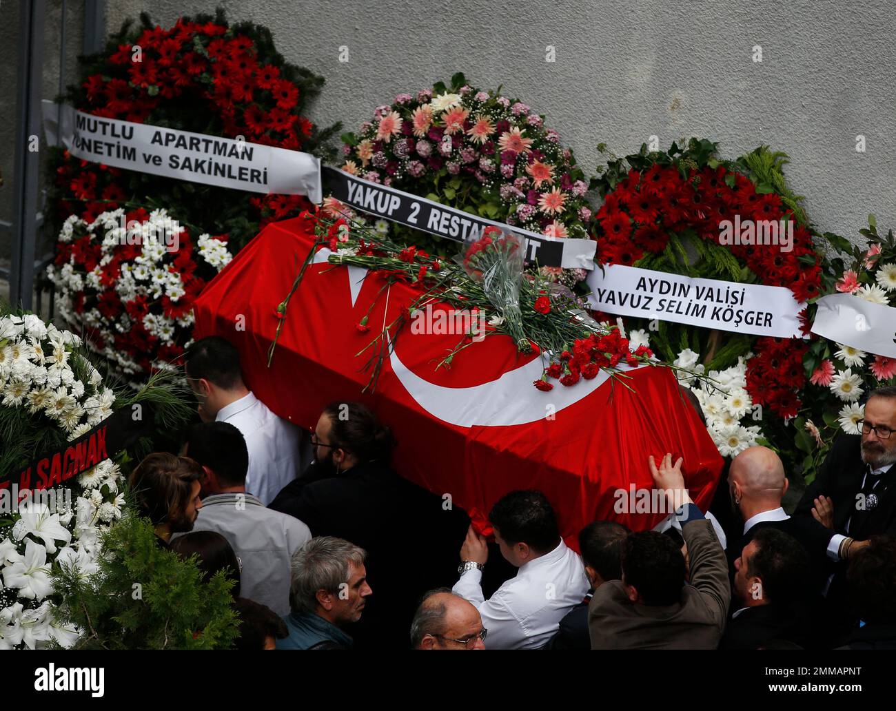 Mourners carry the Turkish flag-draped coffin of acclaimed Turkish ...