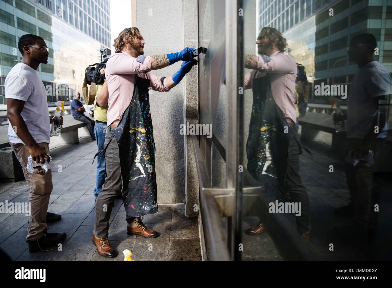 Lead artists, Russell Craig, left, and Jesse Krimes clear a portion of ...