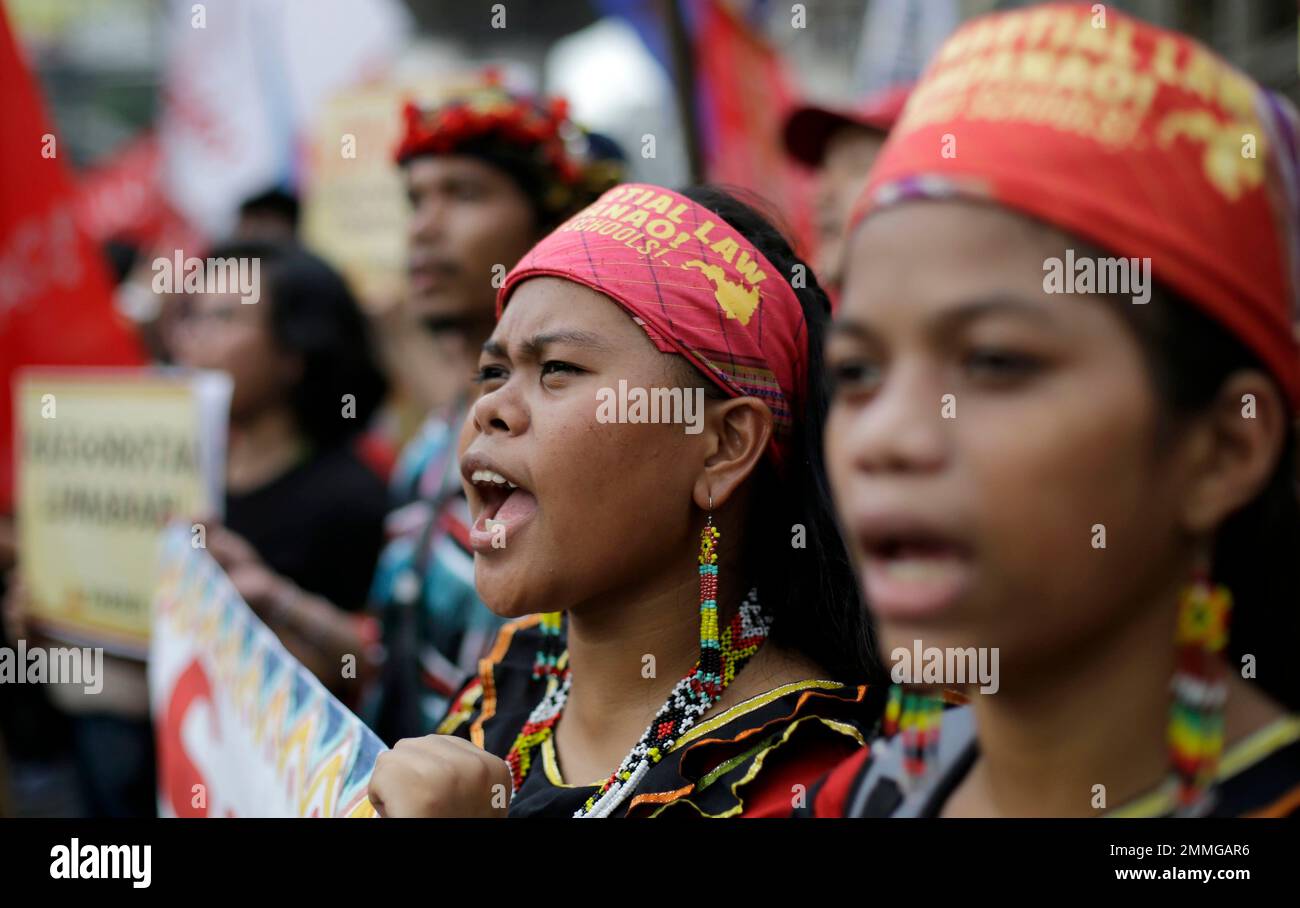 Protesters from the Manobo tribe shout slogans as they join a rally to ...
